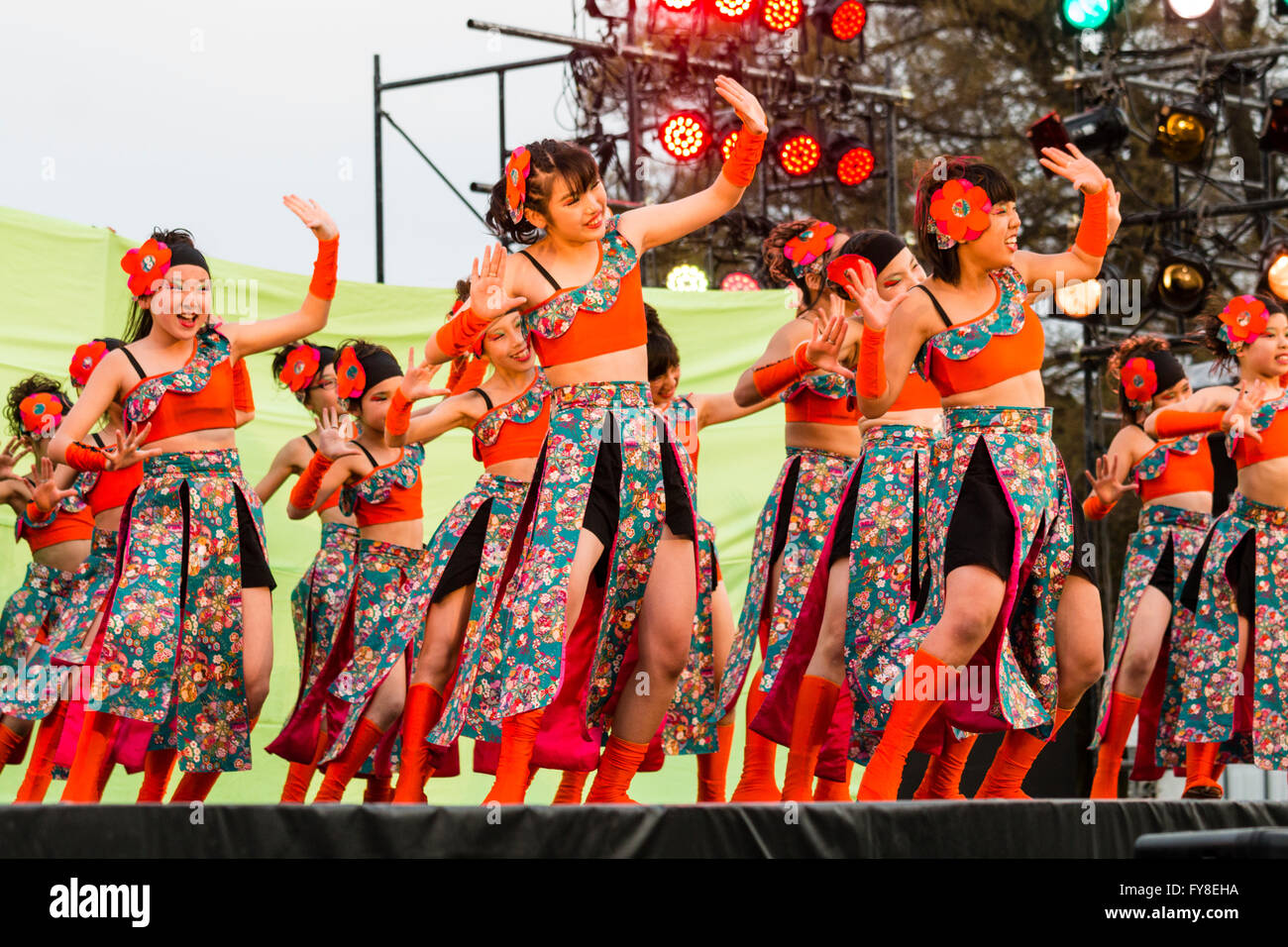 Young Japanese teenage and child dance troupe wearing orange cropped ...