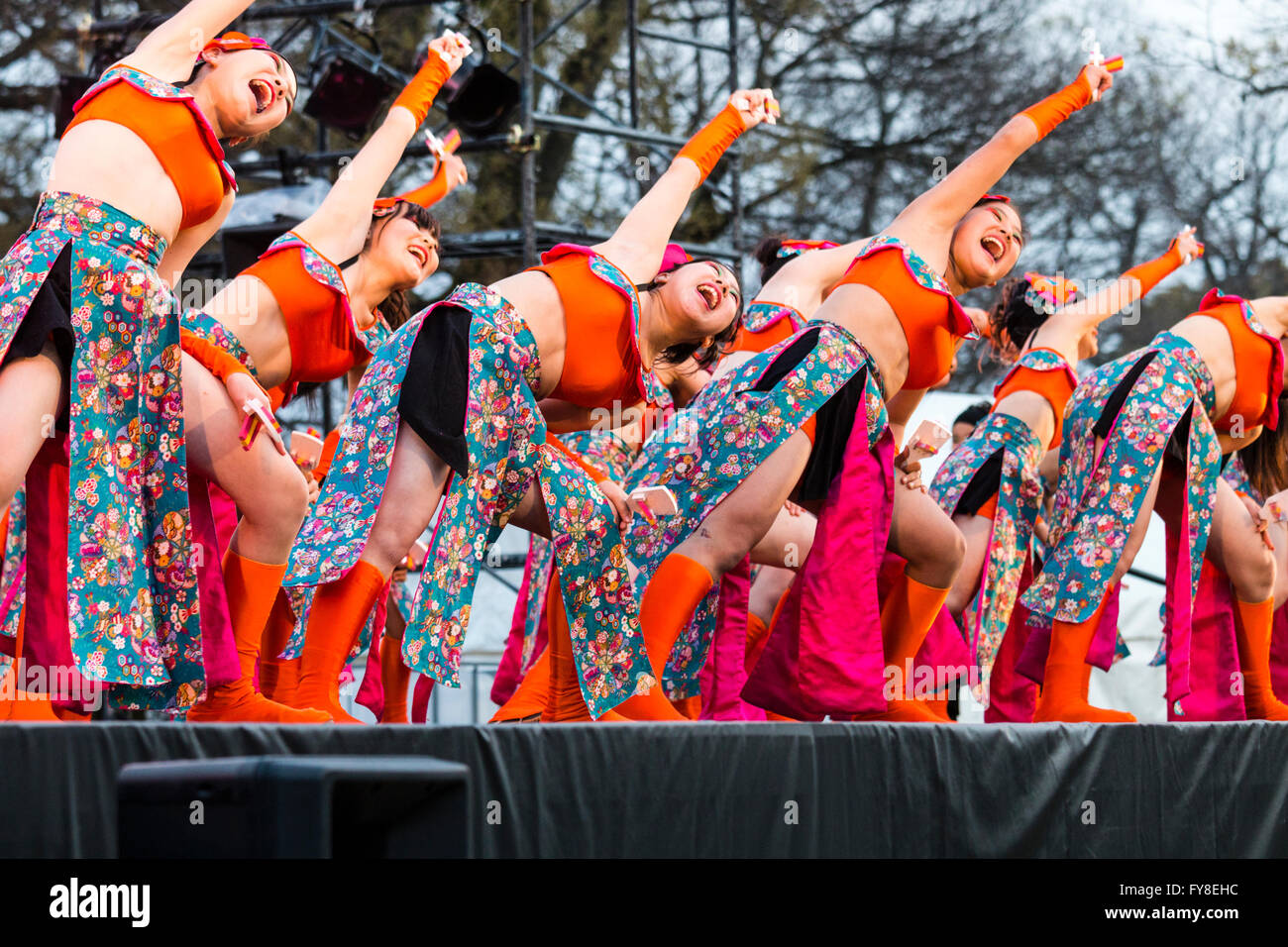 Young Japanese teenage and child dance troupe wearing orange cropped ...