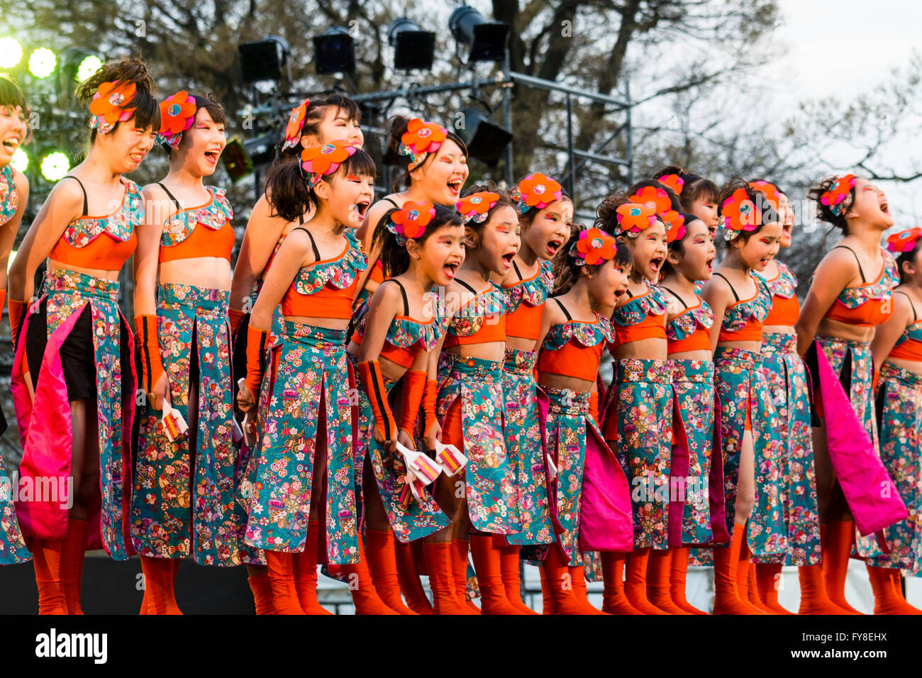 Young Japanese teenage and child dance troupe wearing orange cropped ...
