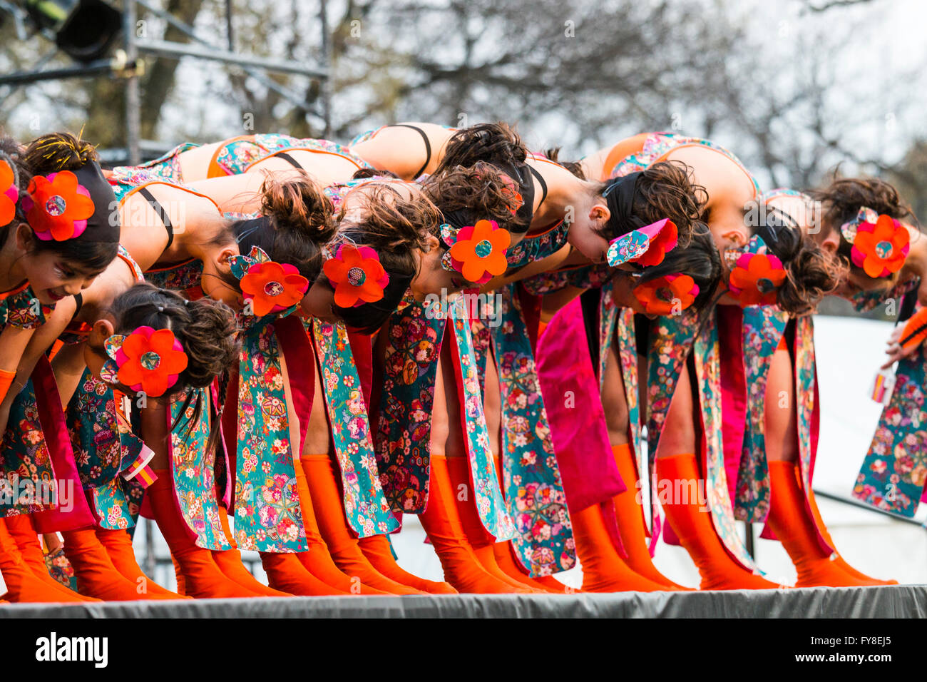 Young Japanese teenage and child dance troupe wearing orange cropped ...