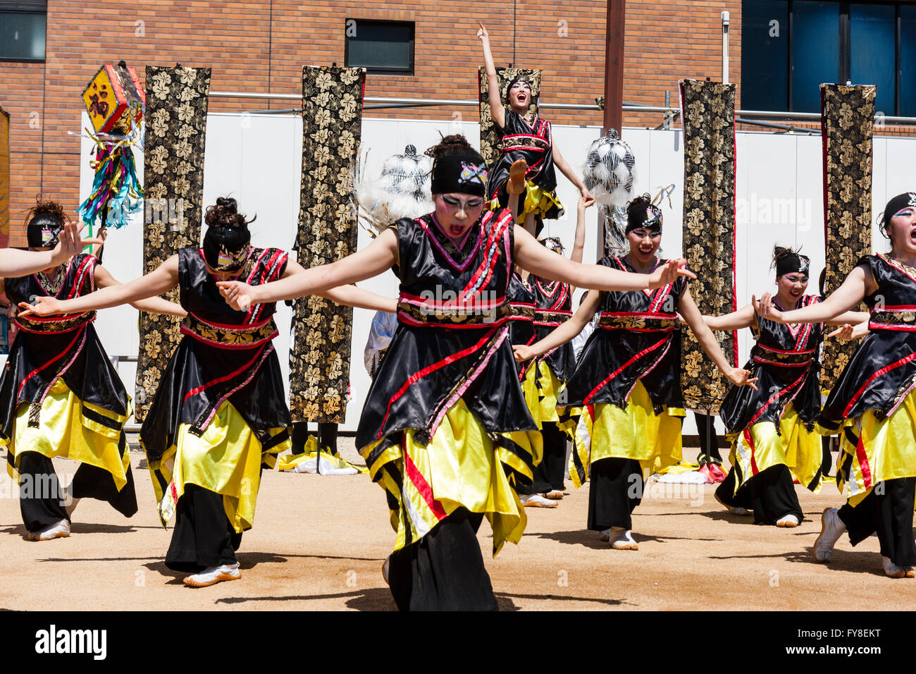 Yosakoi festival, Japan. Young female dance troupe in black and yellow ...