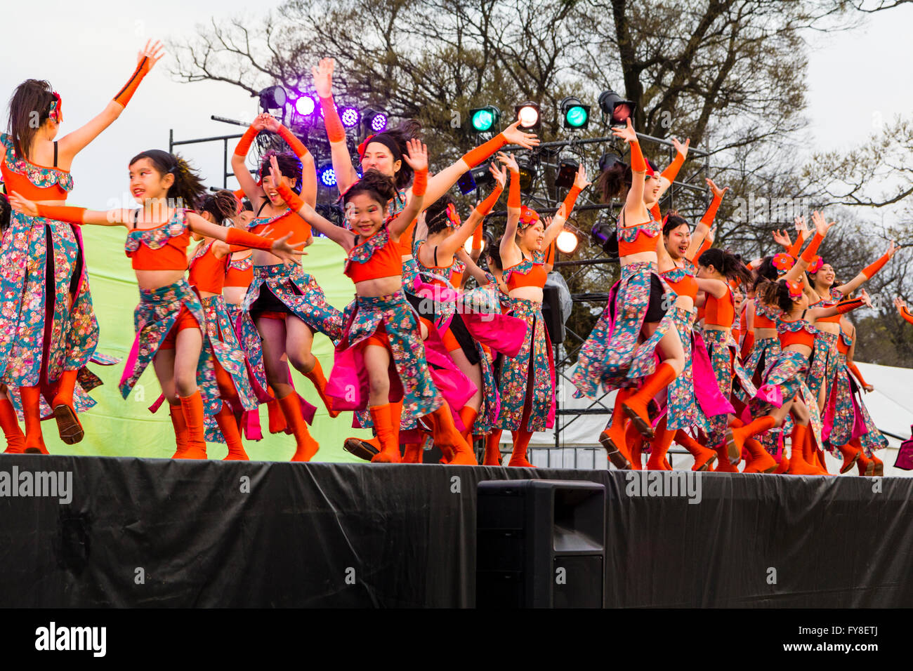 Young Japanese teenage and child dance troupe wearing orange cropped ...