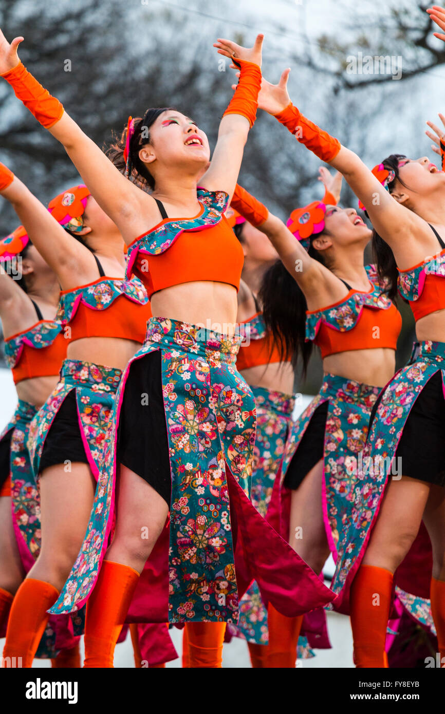 Young Japanese teenage and child dance troupe wearing orange cropped ...