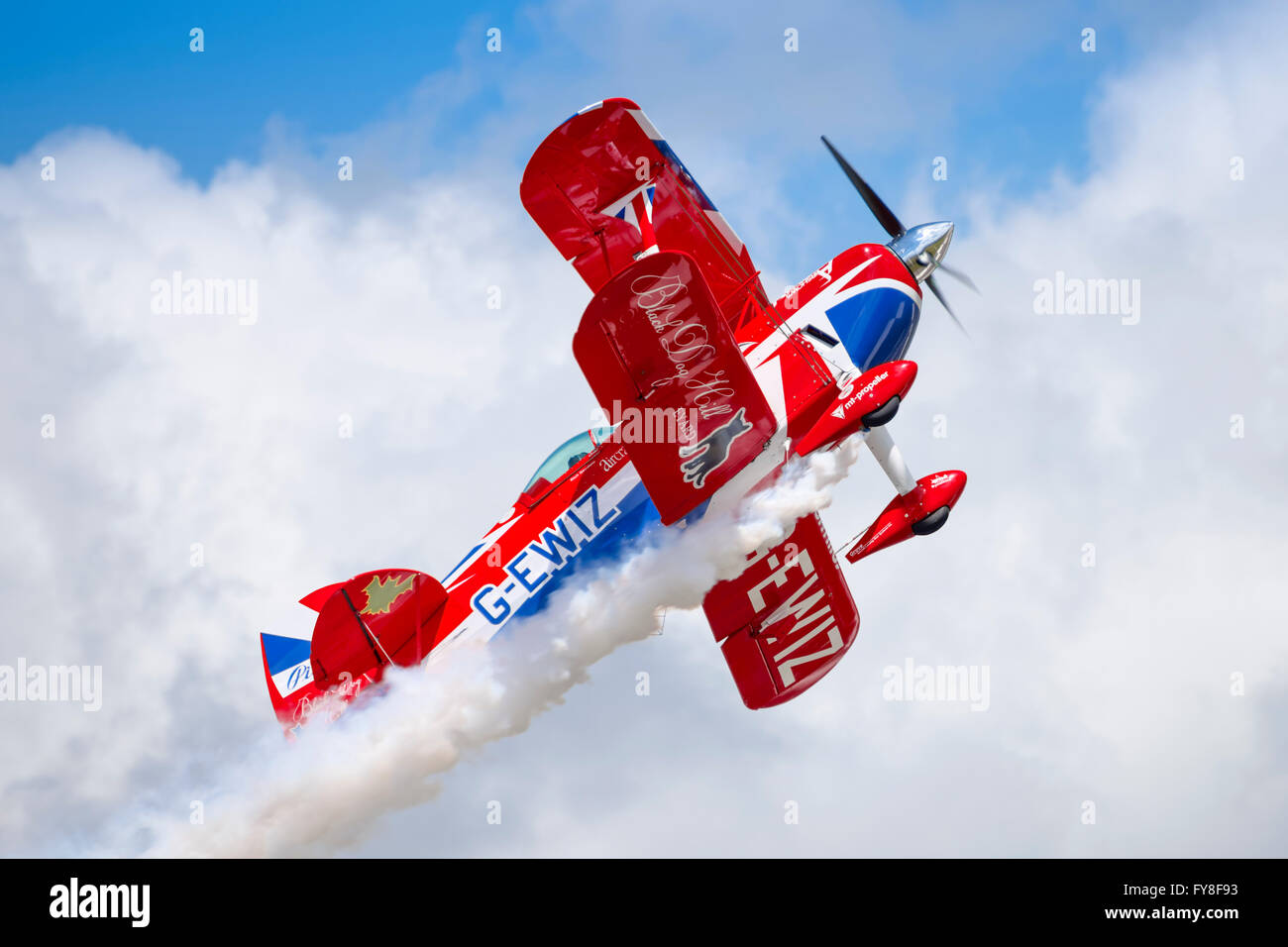 Pitts Special S-2S aerobatic biplane climbing and trailing white smoke ...