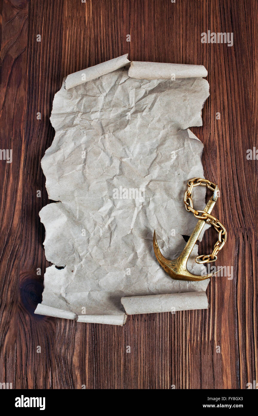 Nautical background. Old scroll and brass anchor Stock Photo - Alamy