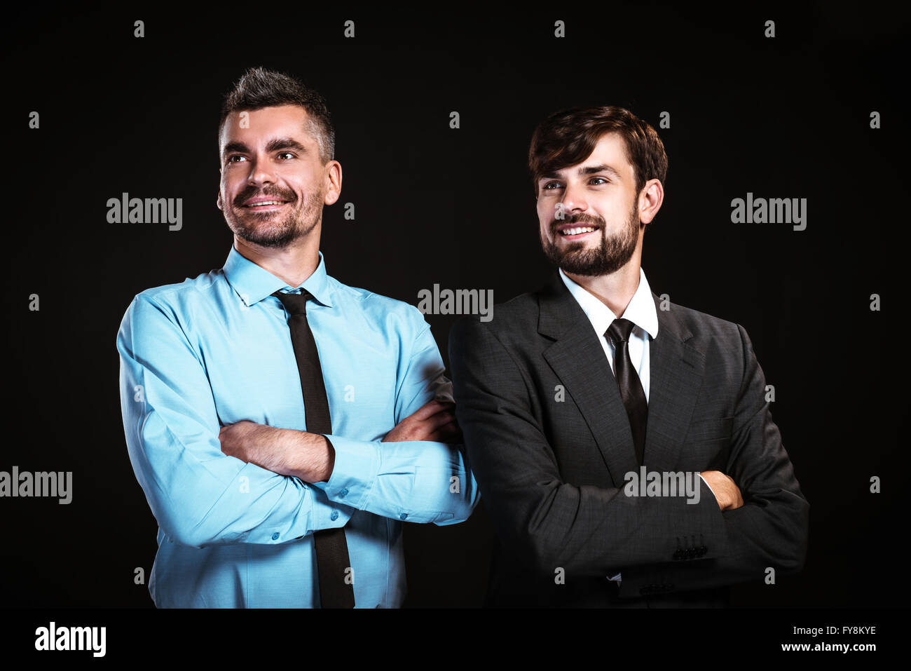 Handsome businessmen on black background Stock Photo - Alamy