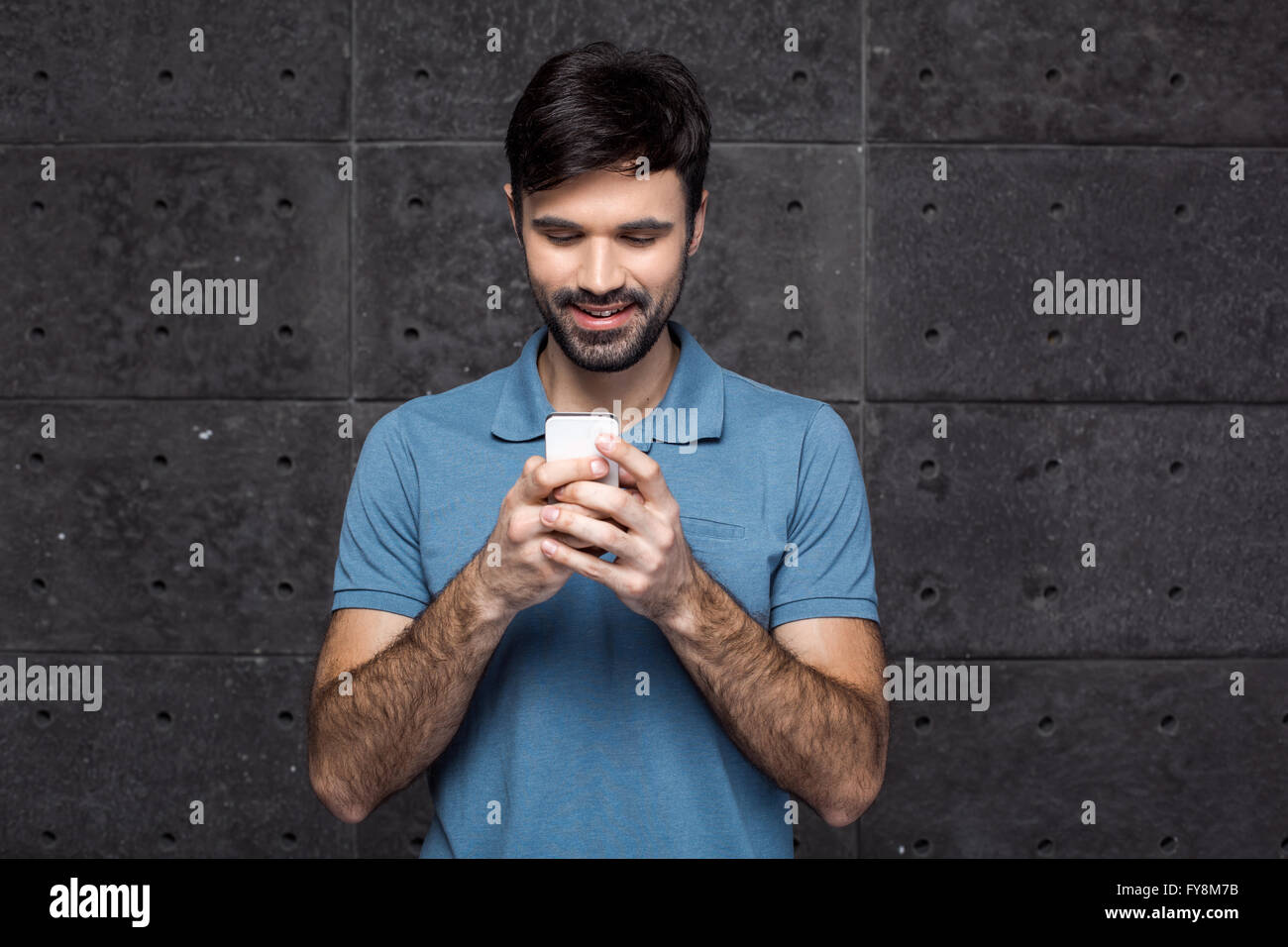 Handsome young man on grey background Stock Photo - Alamy