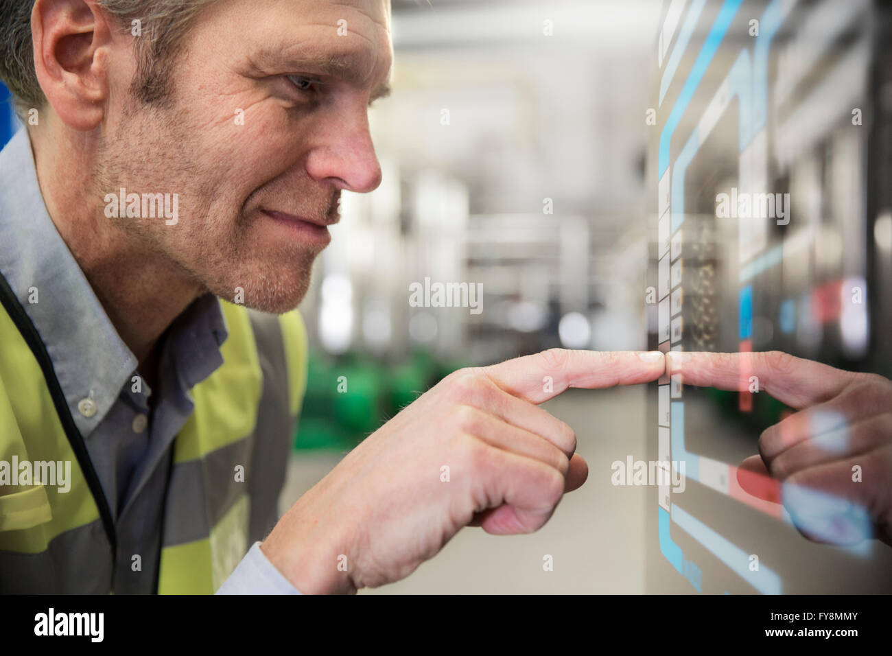Man using touchscreen device in industrial plant Stock Photo - Alamy