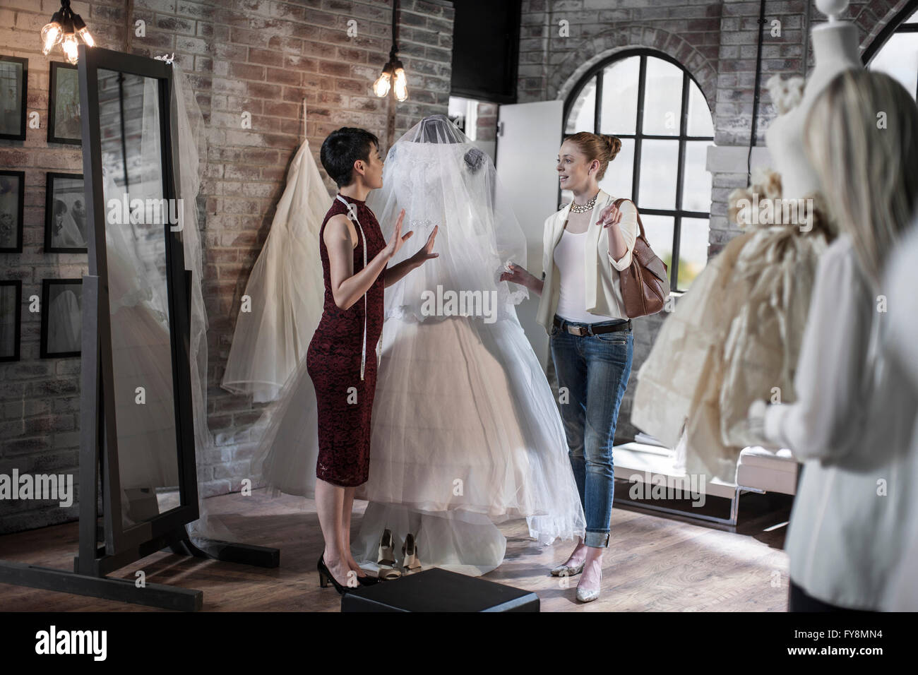 Wedding dress designer and bride to be Stock Photo - Alamy