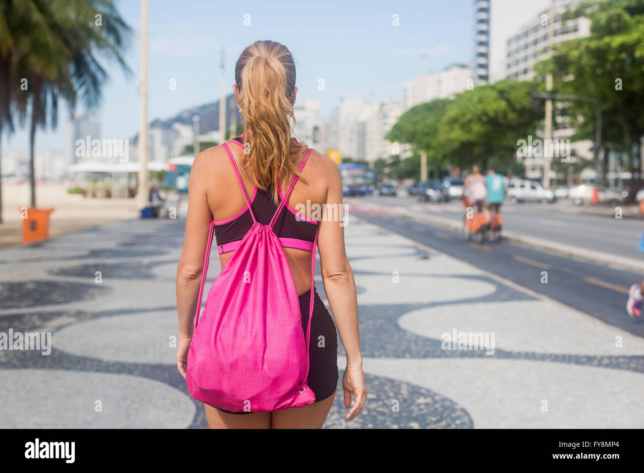 Brazil, Rio de Janeiro, back view of woman walking on pavement Stock ...