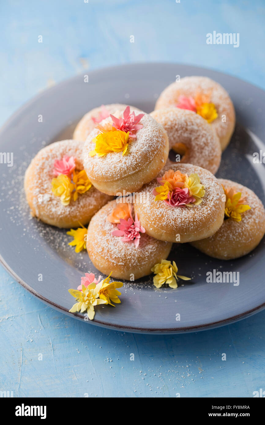 Doughnuts with paper flowers on plate Stock Photo - Alamy