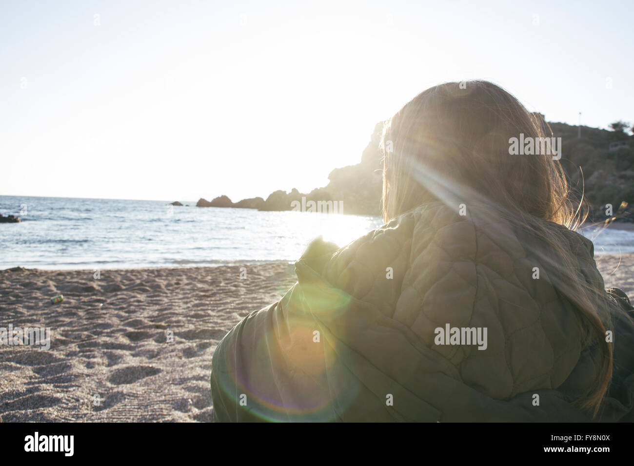 Young woman at the beach looking at sea Stock Photo - Alamy