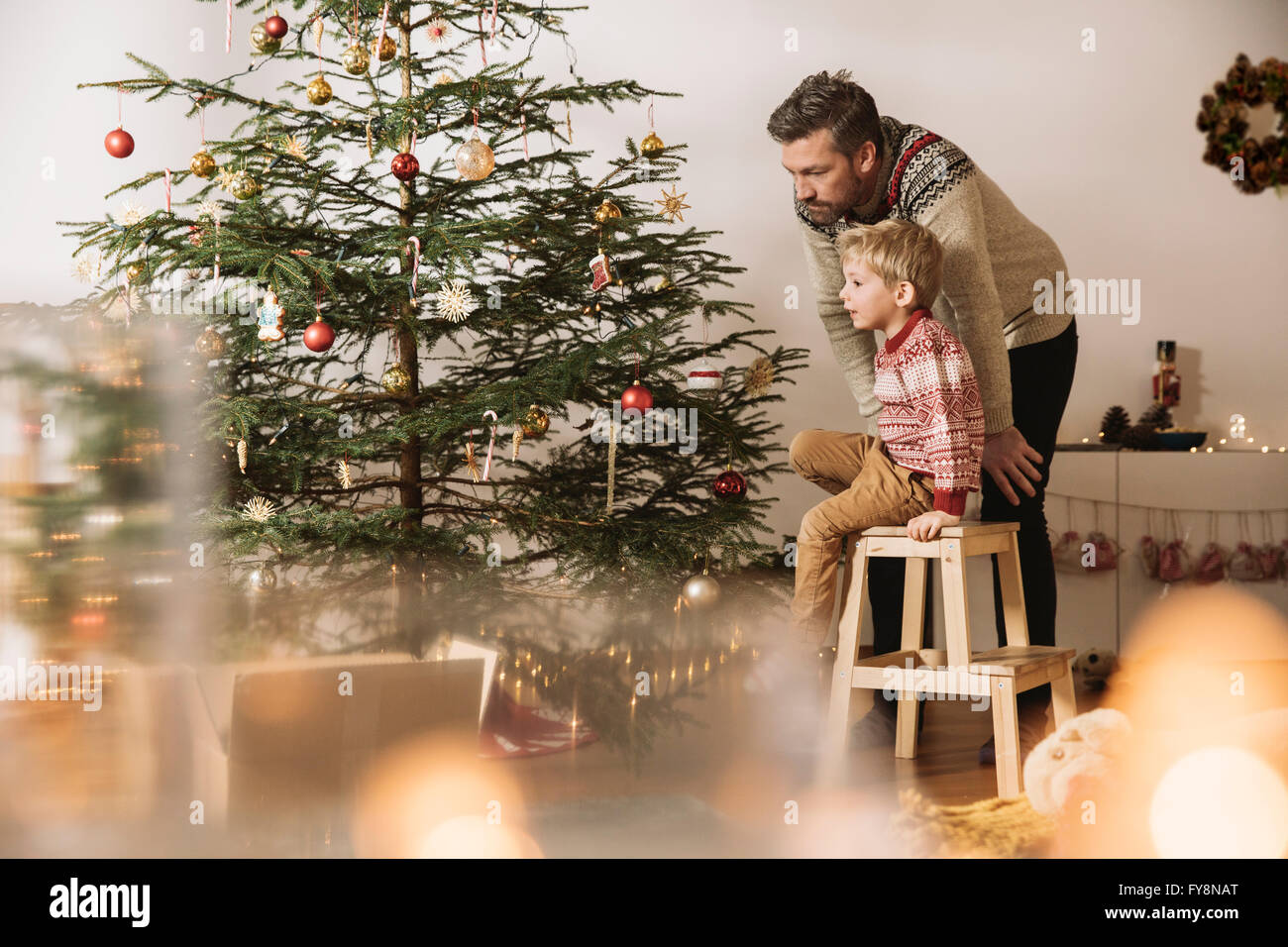Father and son decorating Christmas tree Stock Photo - Alamy