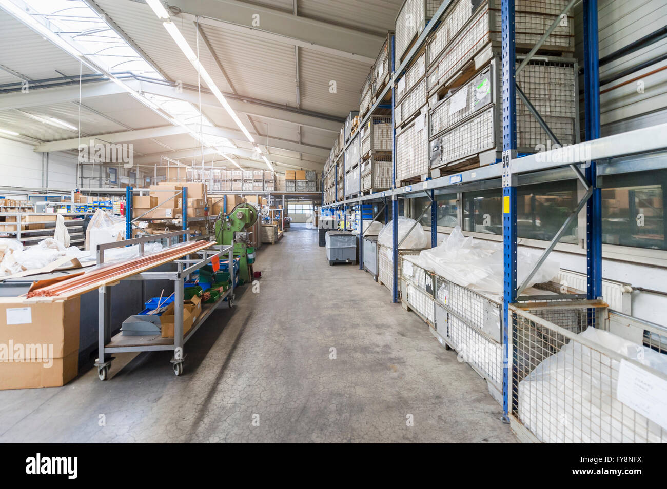 Empty industrial hall with high racks Stock Photo - Alamy