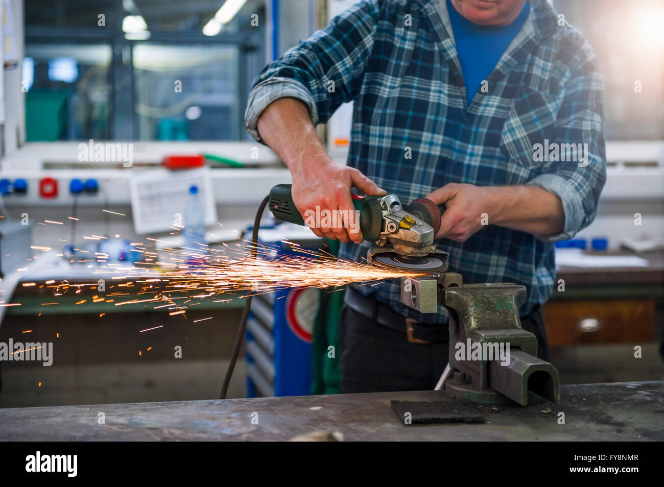 Man working with grinding machine Stock Photo - Alamy
