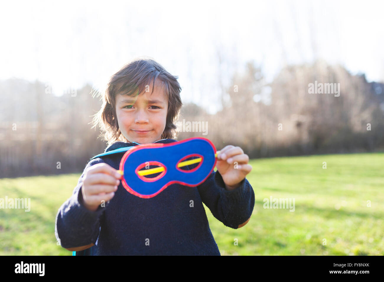 Portrait of little boy showing his superhero eye mask Stock Photo - Alamy