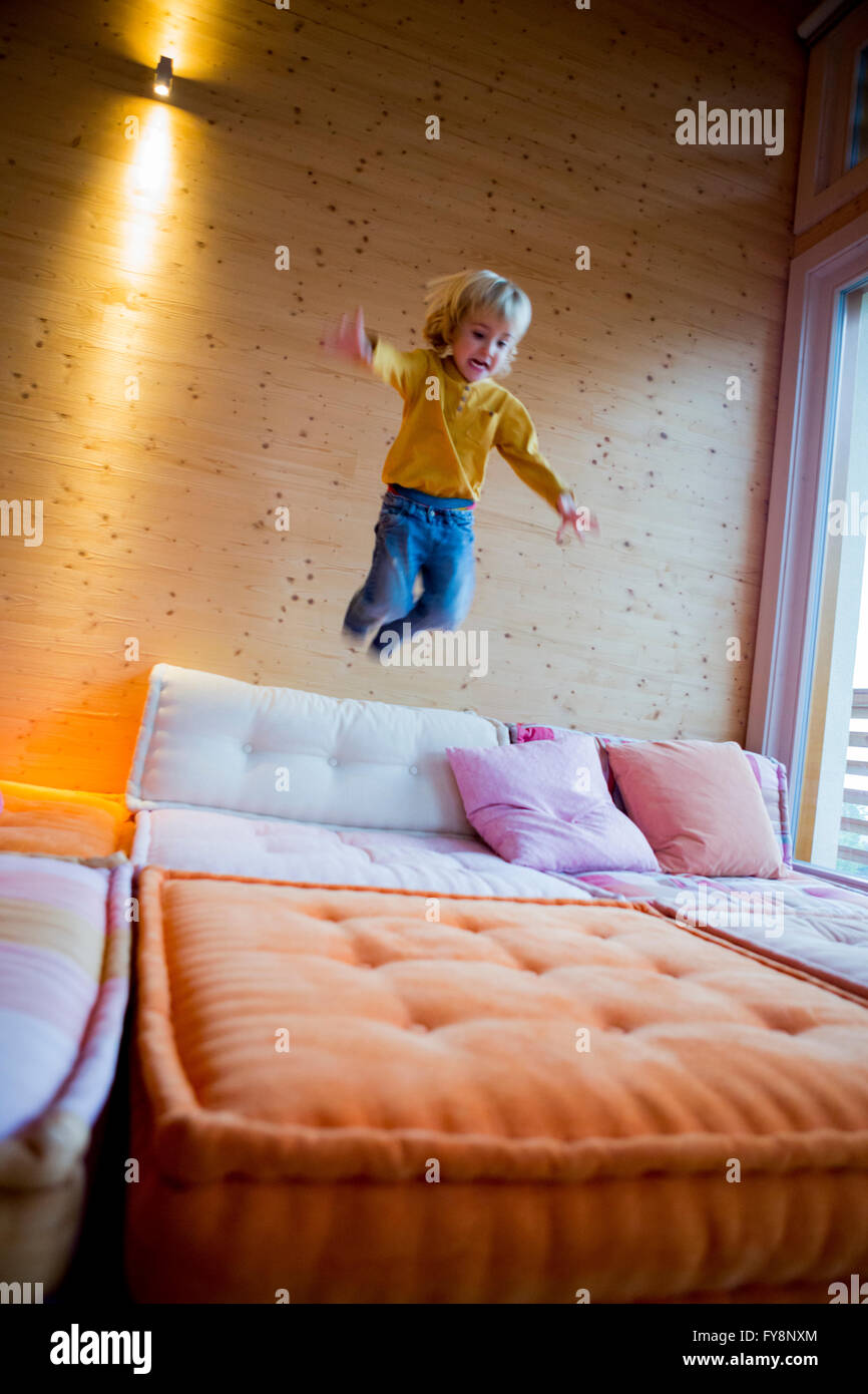 Little boy jumping on the couch at home Stock Photo - Alamy