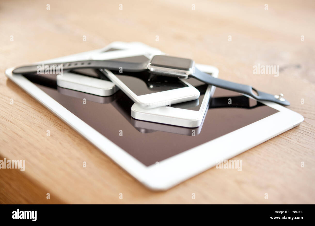 Stack of smartwatch, three smartphones and a digital tablet Stock Photo ...