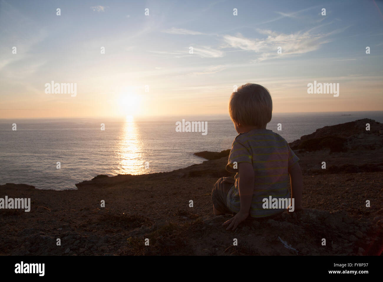 Back view of little boy watching sunset Stock Photo - Alamy