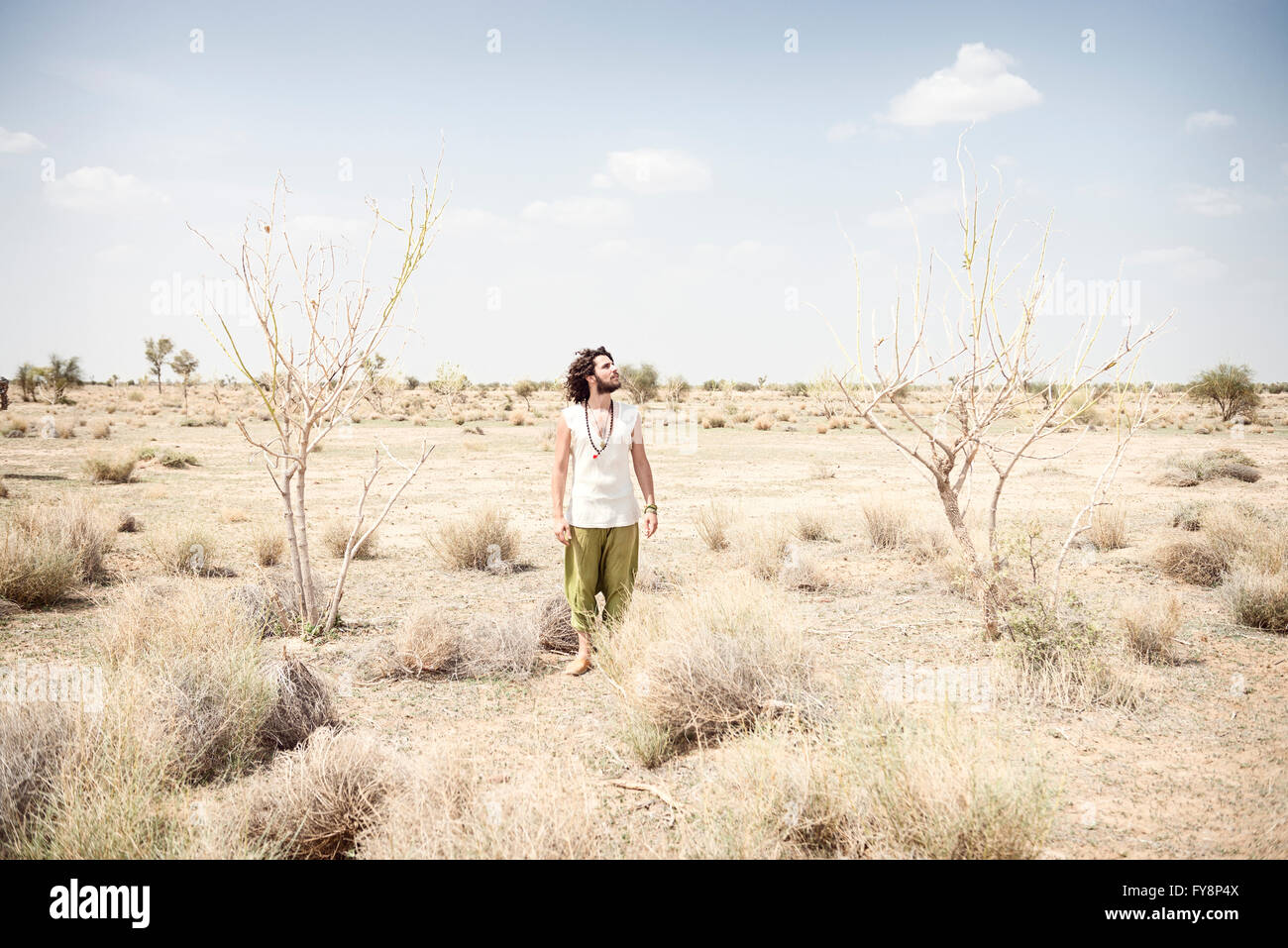 Man standing alone in the desert Stock Photo - Alamy
