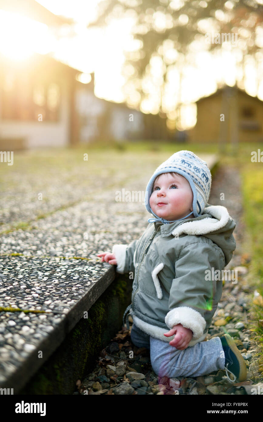 Portrait of baby girl looking up watching something Stock Photo - Alamy