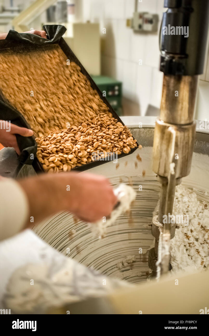 Italy, Manufacturing of traditional torrone in confectionery, putting ...