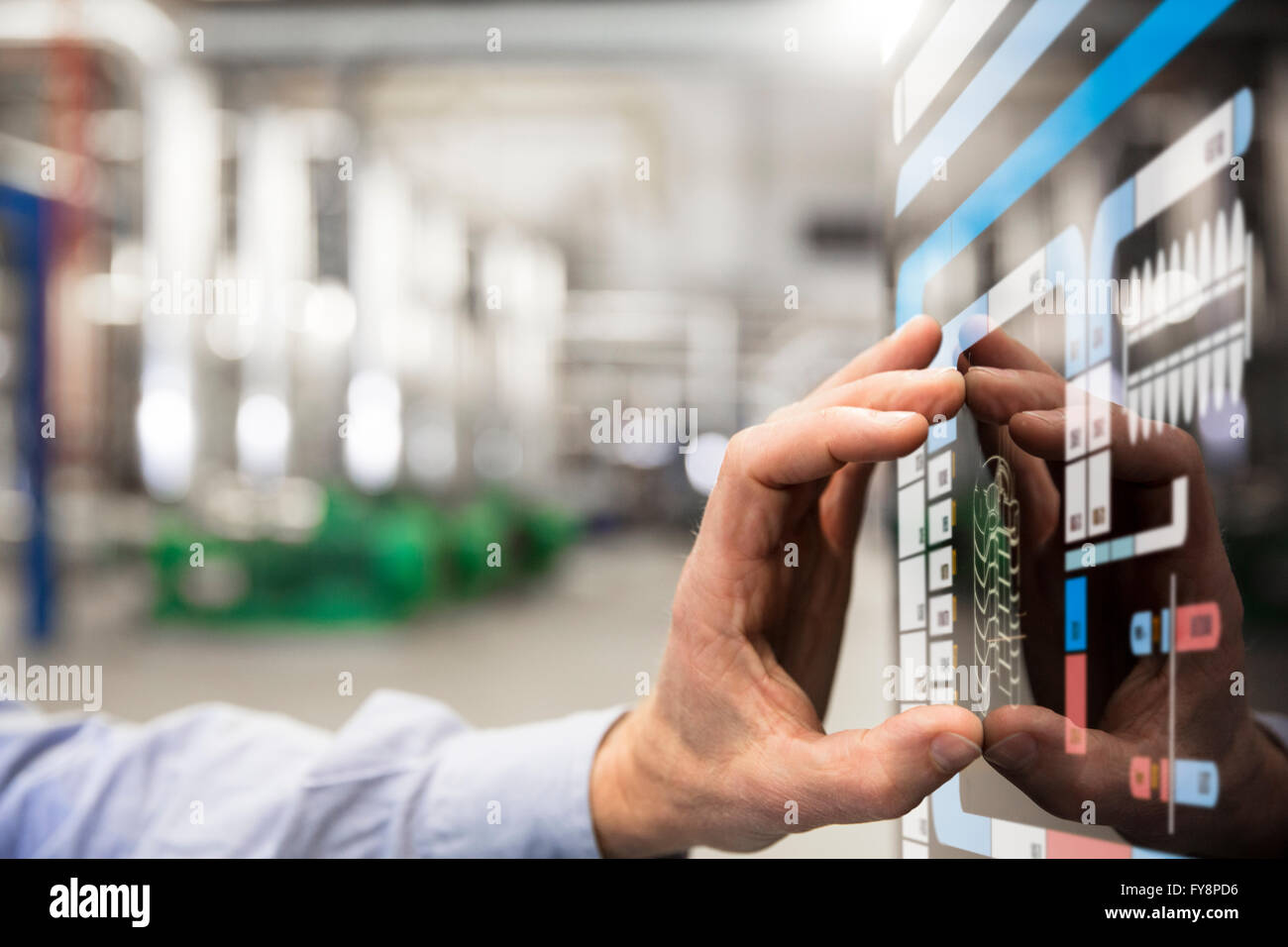 Man using touchscreen device in industrial plant Stock Photo - Alamy