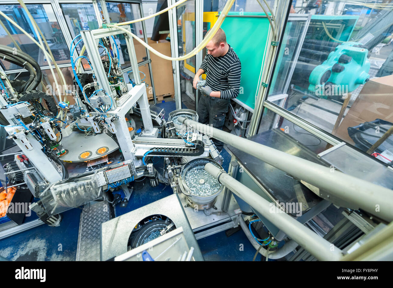 Man in factory working at sorting machine Stock Photo - Alamy