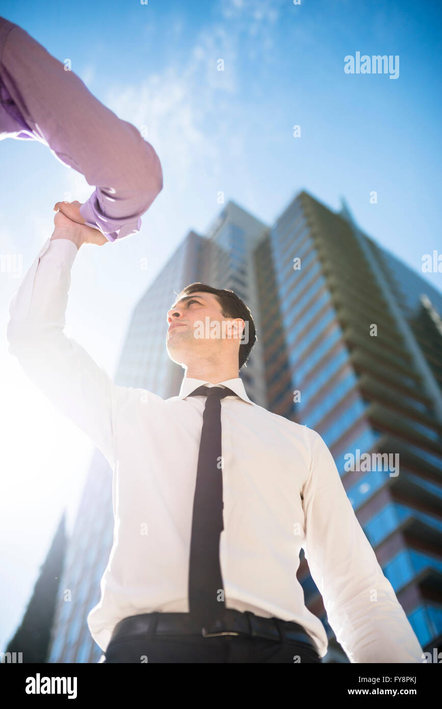 Two businessmen high fiving hi-res stock photography and images - Alamy