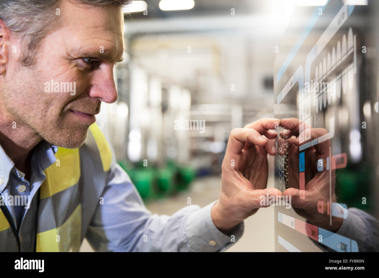 Man using touchscreen device in industrial plant Stock Photo - Alamy