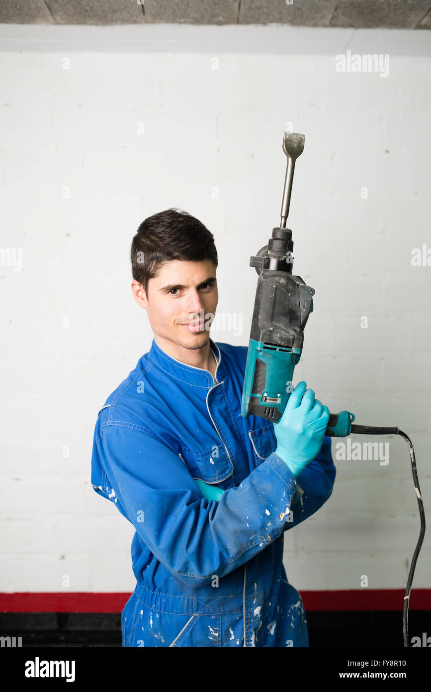 Portrait of a construction worker holding jackhammer Stock Photo - Alamy