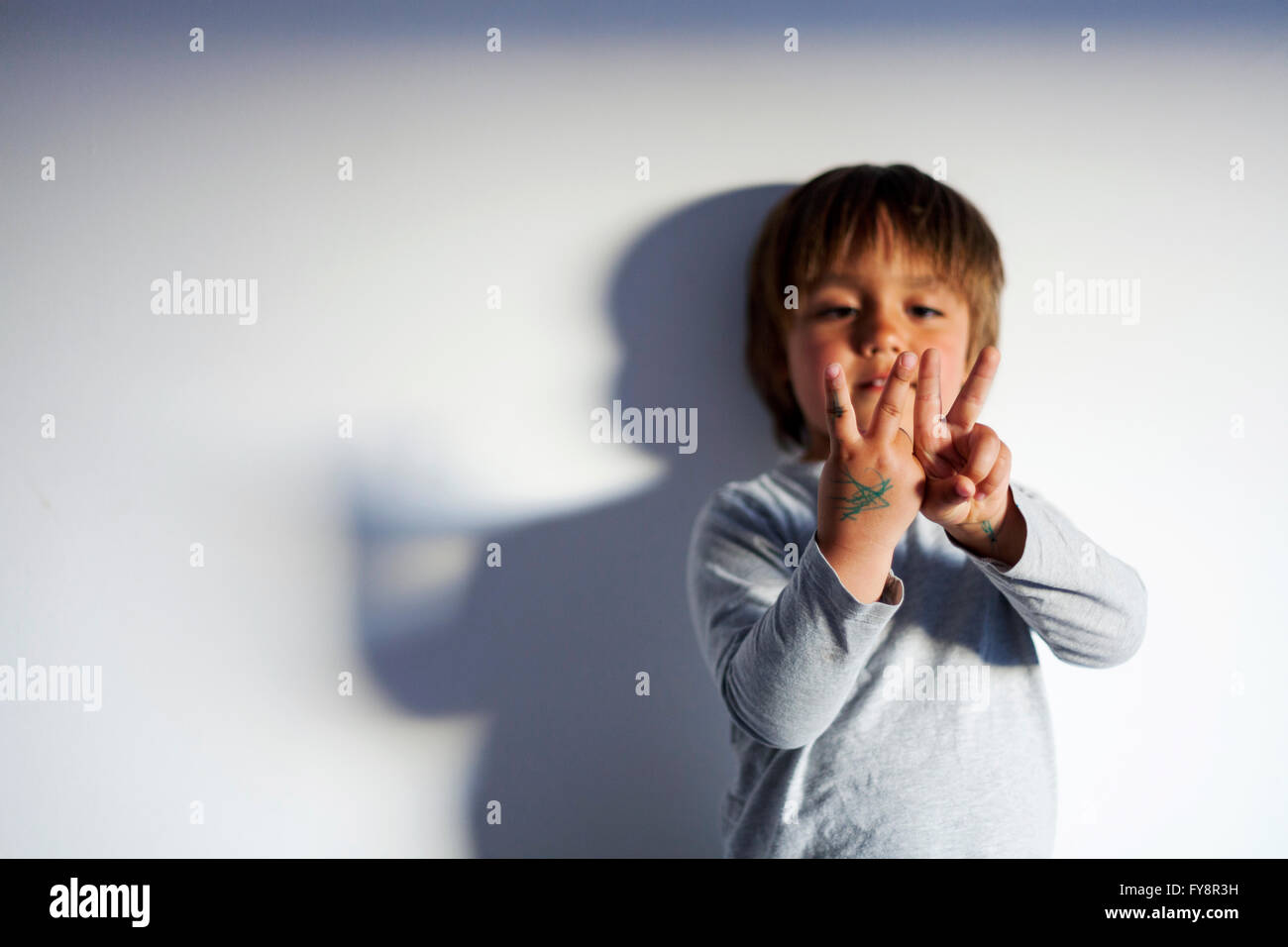 Little boy counting with his fingers Stock Photo - Alamy