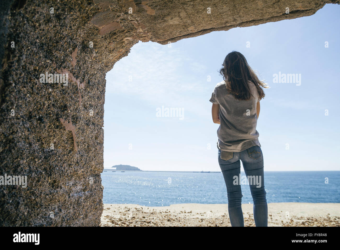 Young woman at the beach looking at sea Stock Photo - Alamy