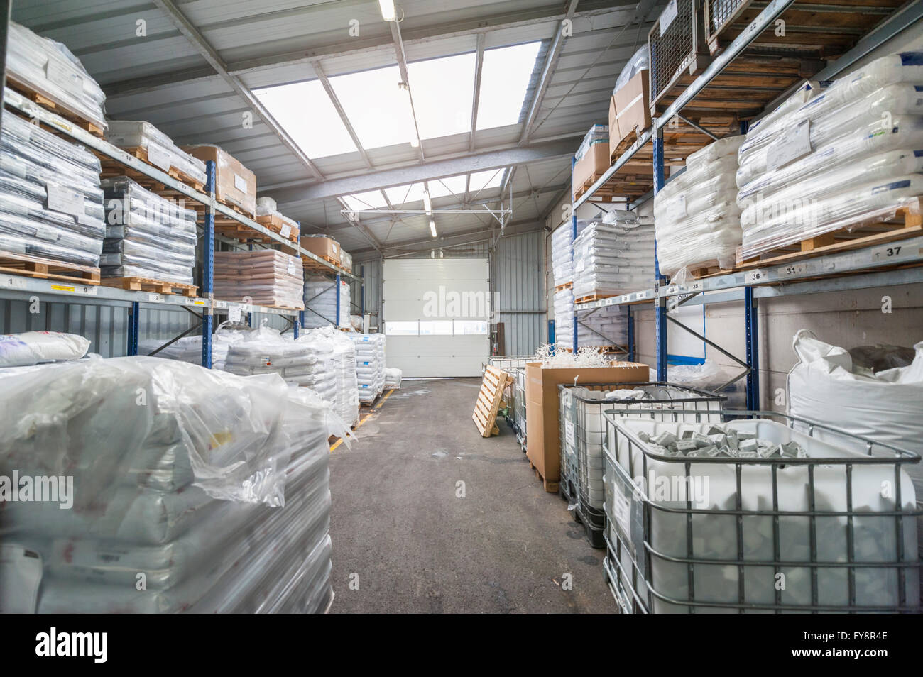Empty industrial hall with high racks Stock Photo - Alamy