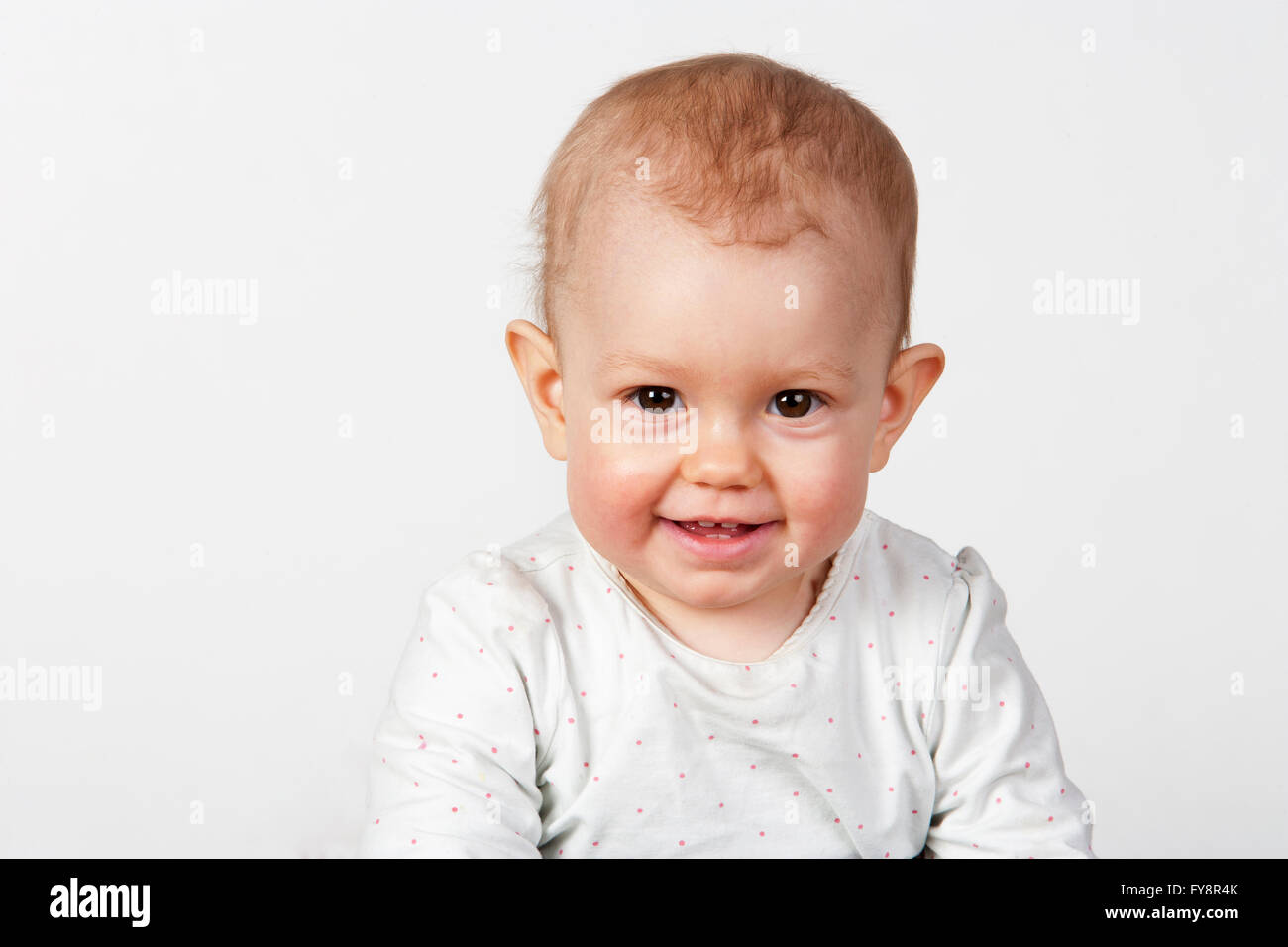 Portrait of smiling baby girl in front of white background Stock Photo ...