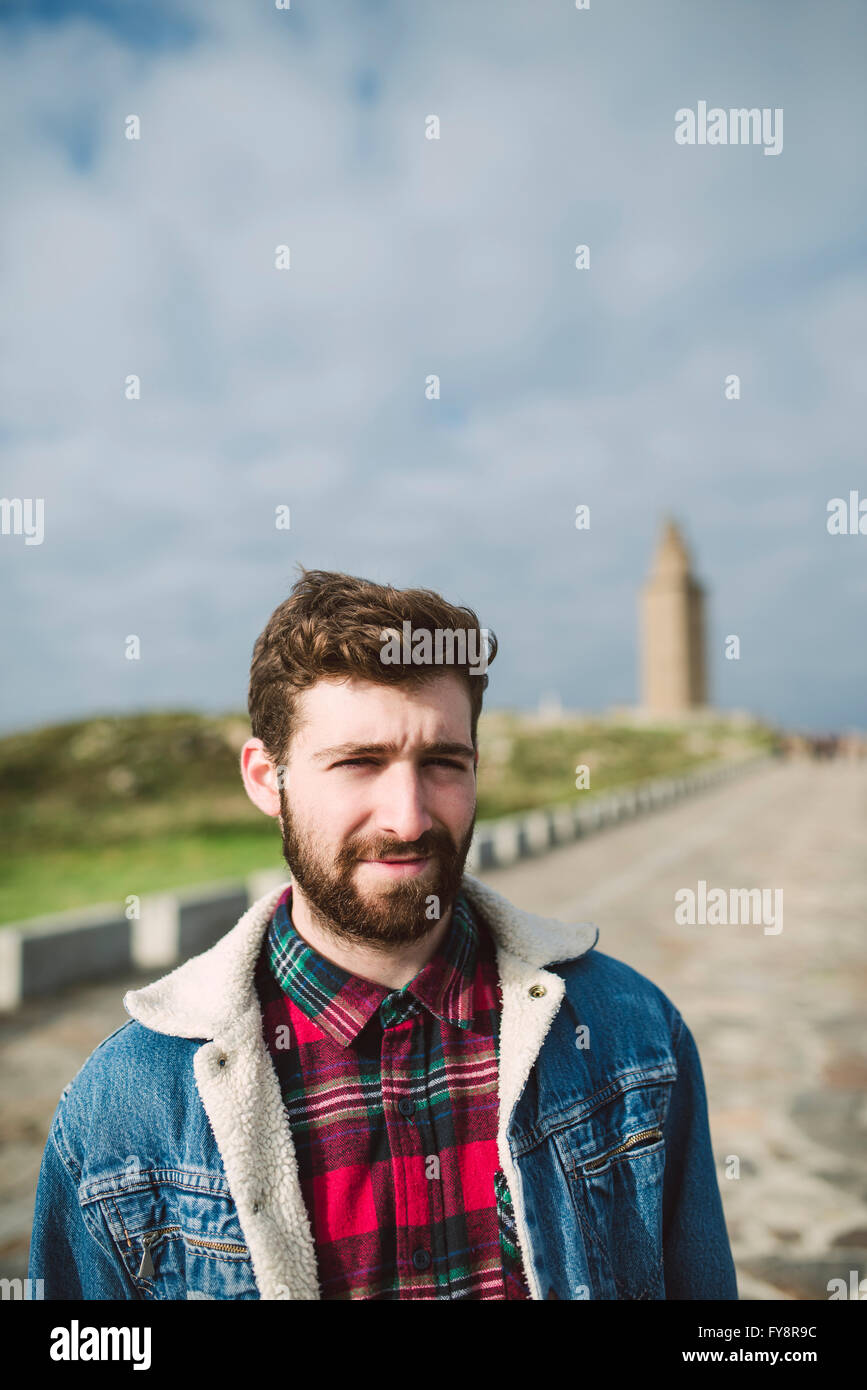 Spain, A Coruna, portrait of young man with brown hair and full beard ...