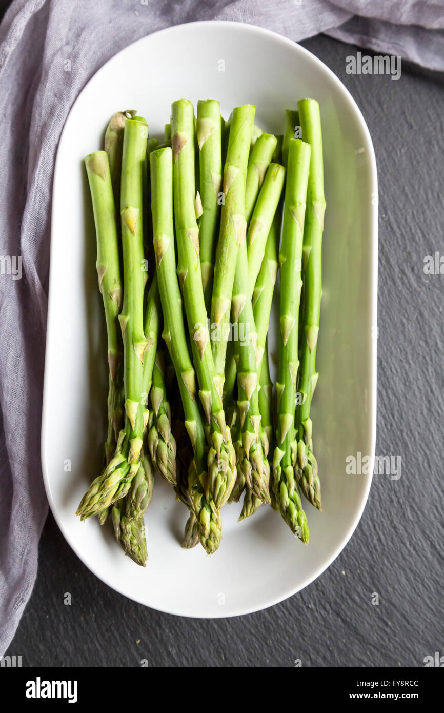 Platter with mini organic green asparagus Stock Photo - Alamy