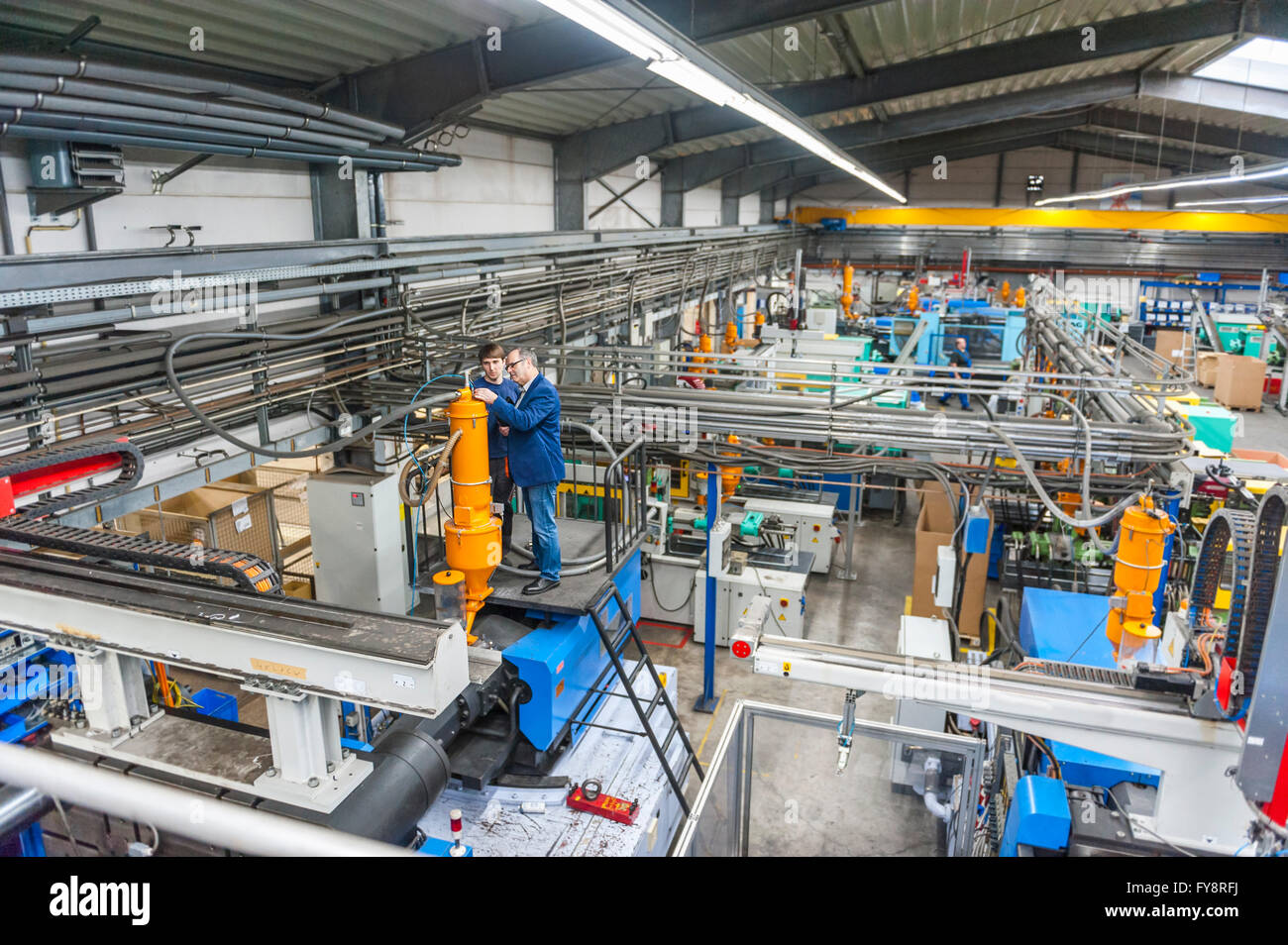 Manager and worker having work meeting in plastics factory Stock Photo ...
