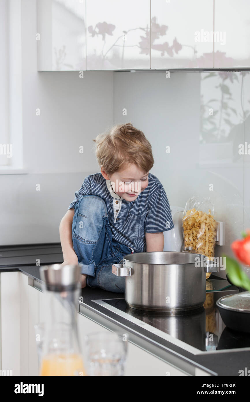 Little boy helping to prepare food in the kitchen Stock Photo - Alamy