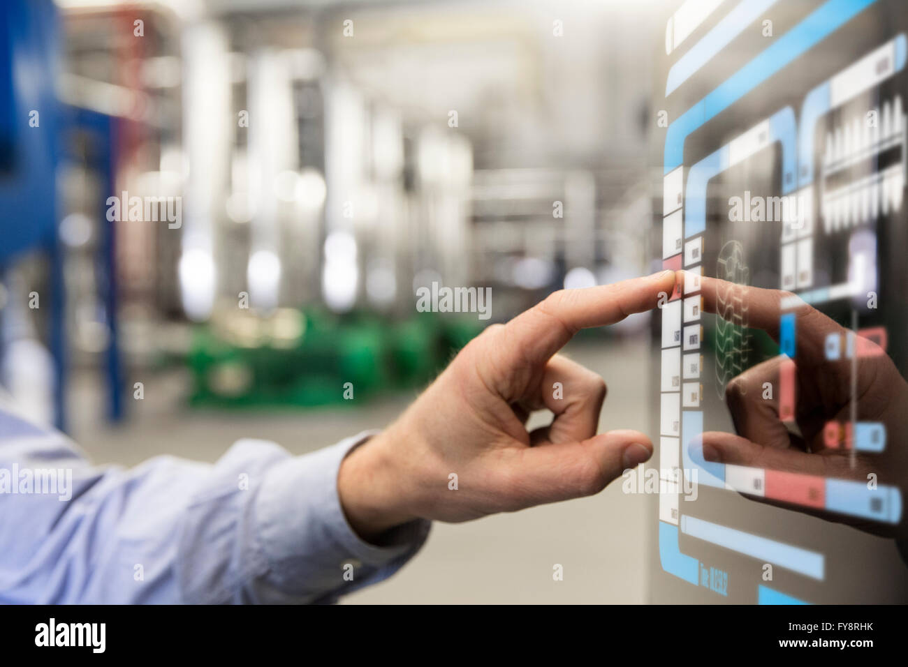 Man using touchscreen device in industrial plant Stock Photo - Alamy