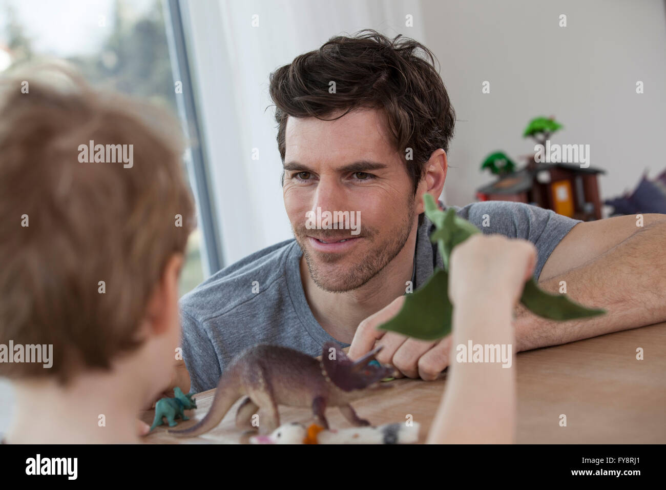 Father and son playing with toys Stock Photo - Alamy