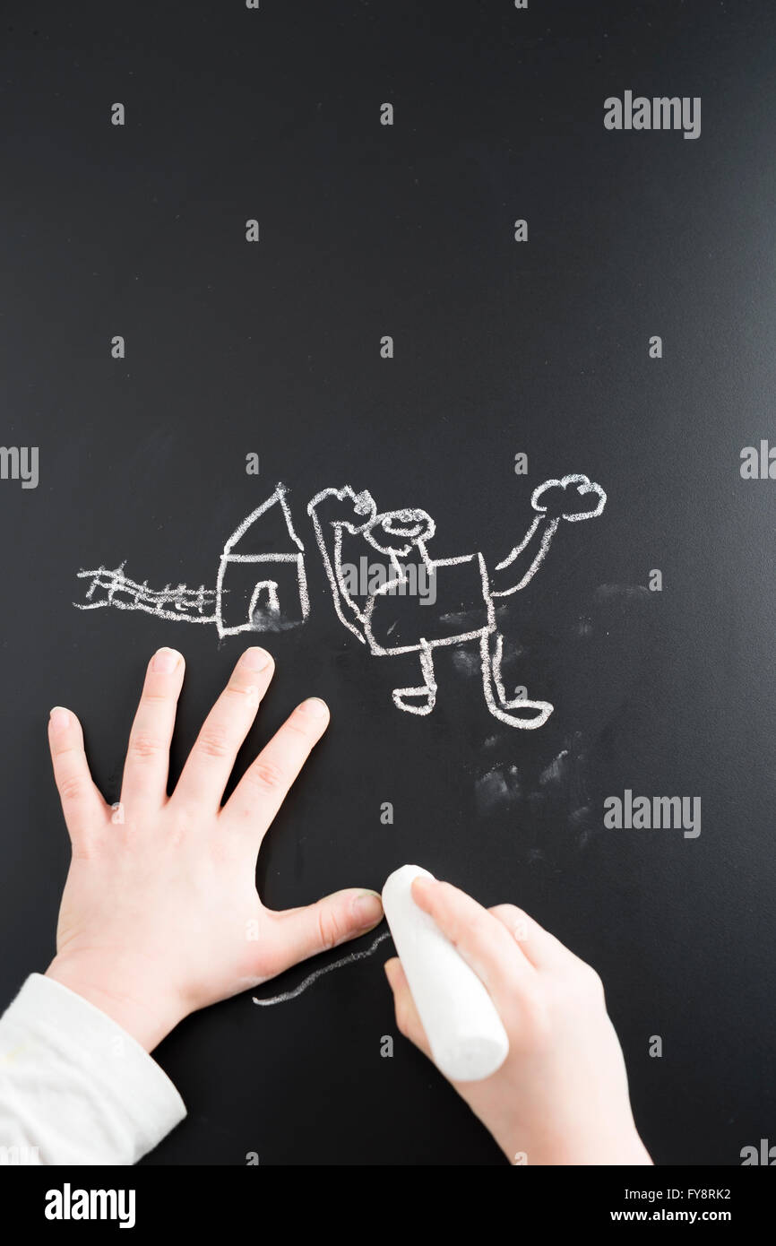 Little boy's hands drawing on blackboard Stock Photo - Alamy