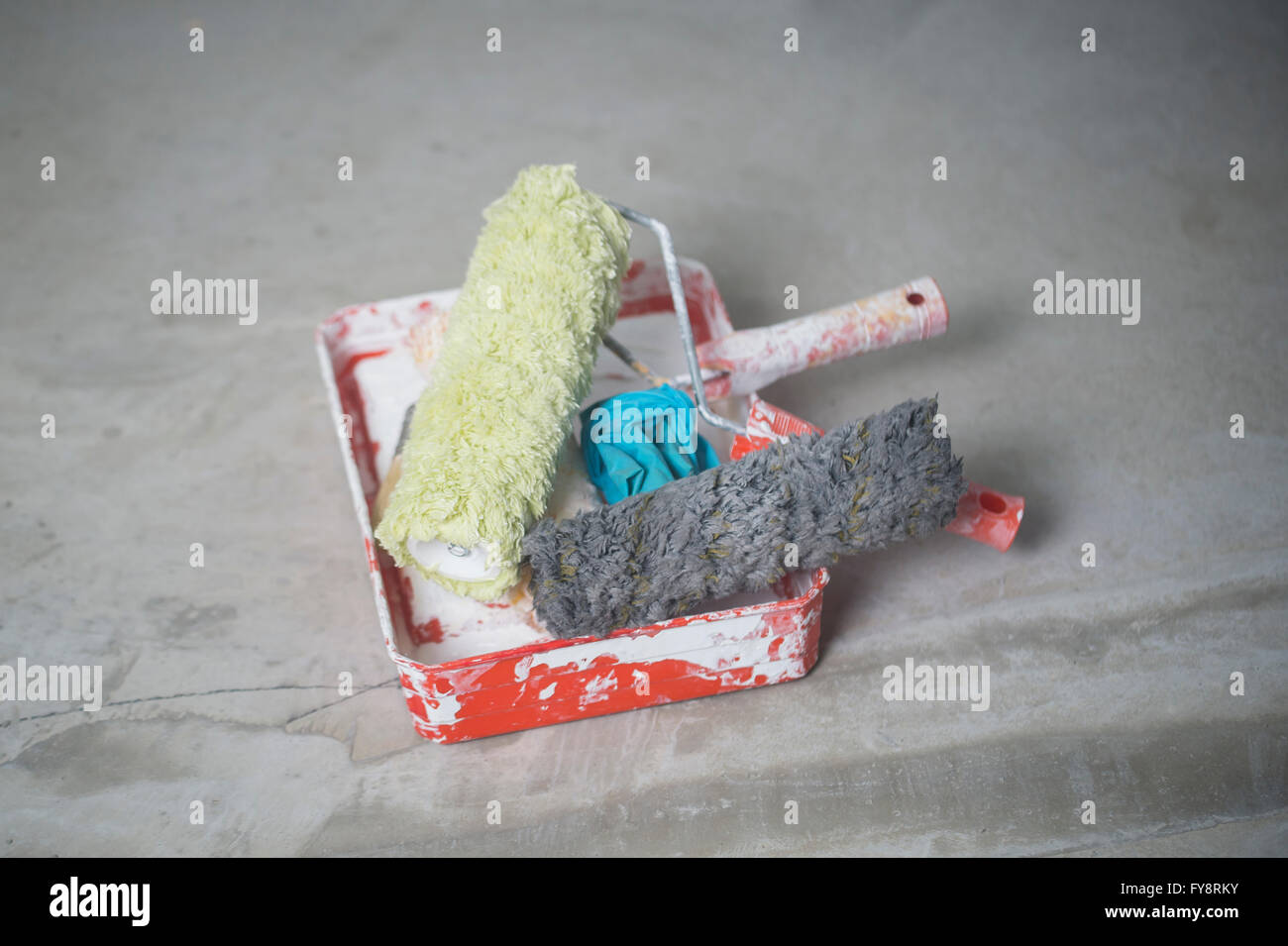 Rollers and paint drawer on cement floor Stock Photo - Alamy