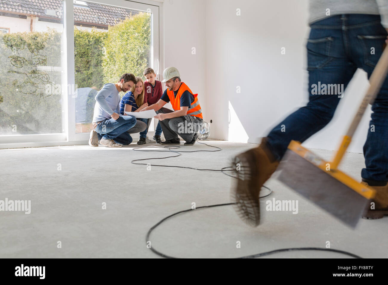 Construction worker explaining family the construction plan Stock Photo ...