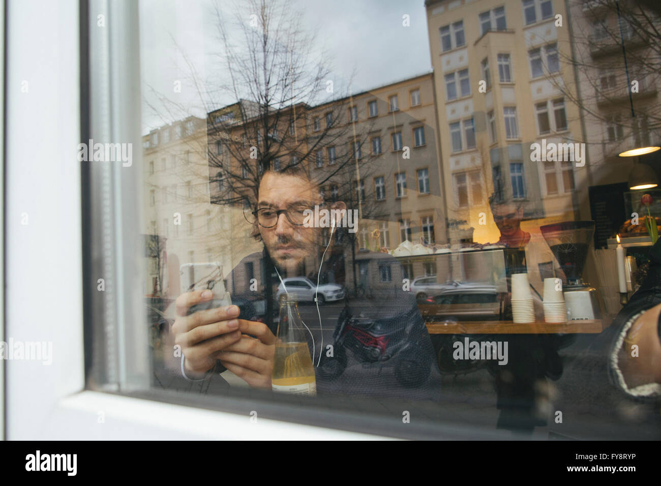 Man in a cafe behind windowpane Stock Photo - Alamy