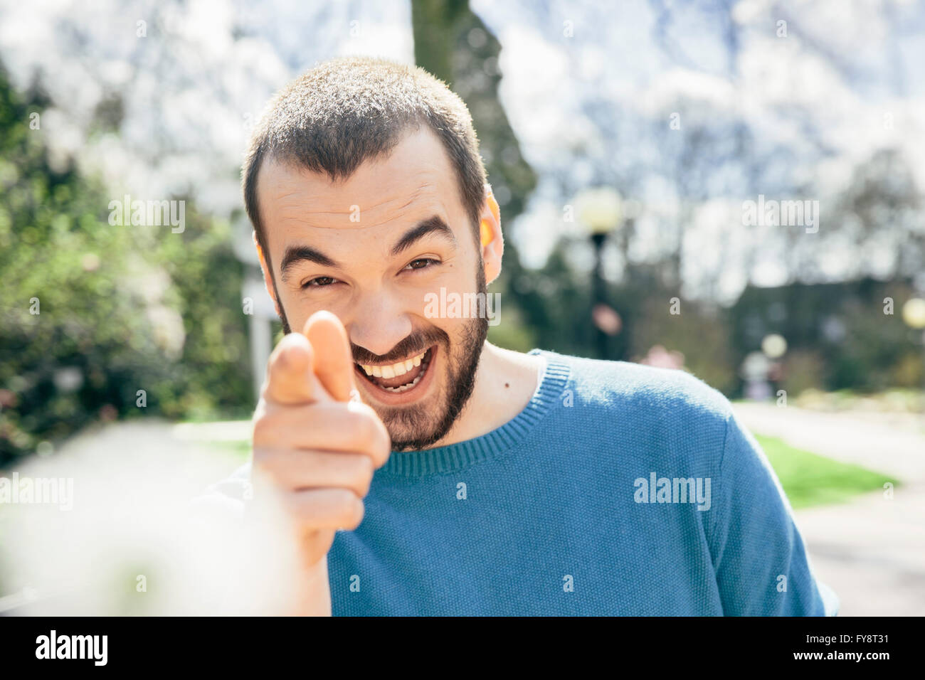 Laughing man pointing on viewer Stock Photo - Alamy