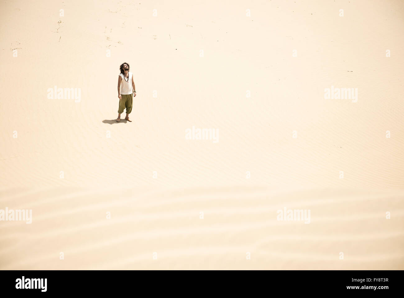 Man standing alone in the desert Stock Photo - Alamy
