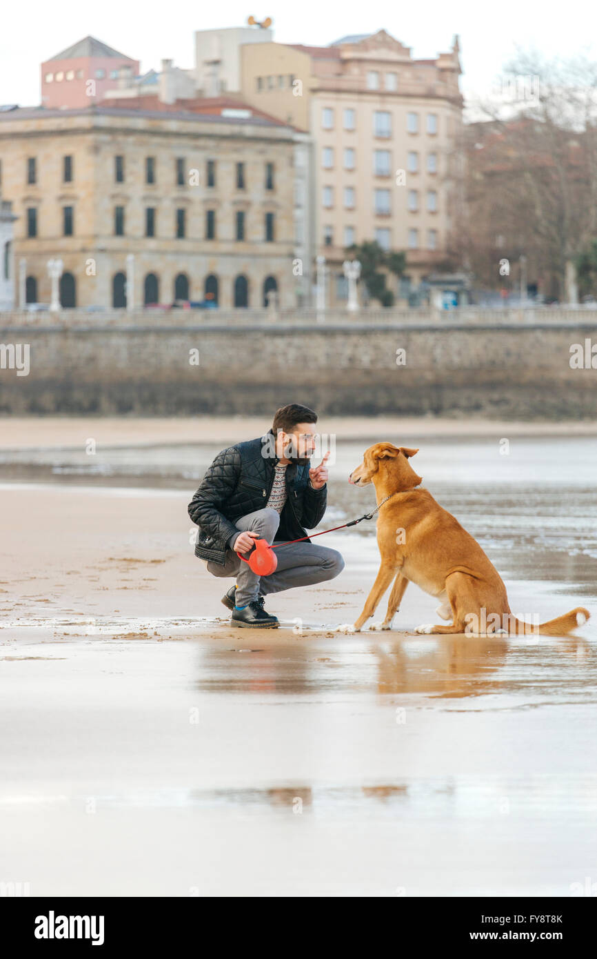 Man talking his dog on beach hi-res stock photography and images - Alamy