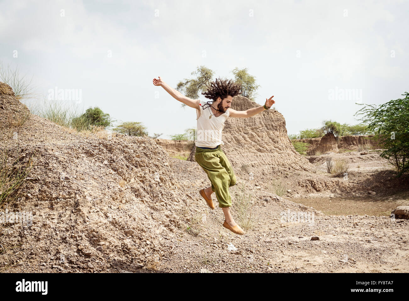 Man jumping in landscape Stock Photo - Alamy