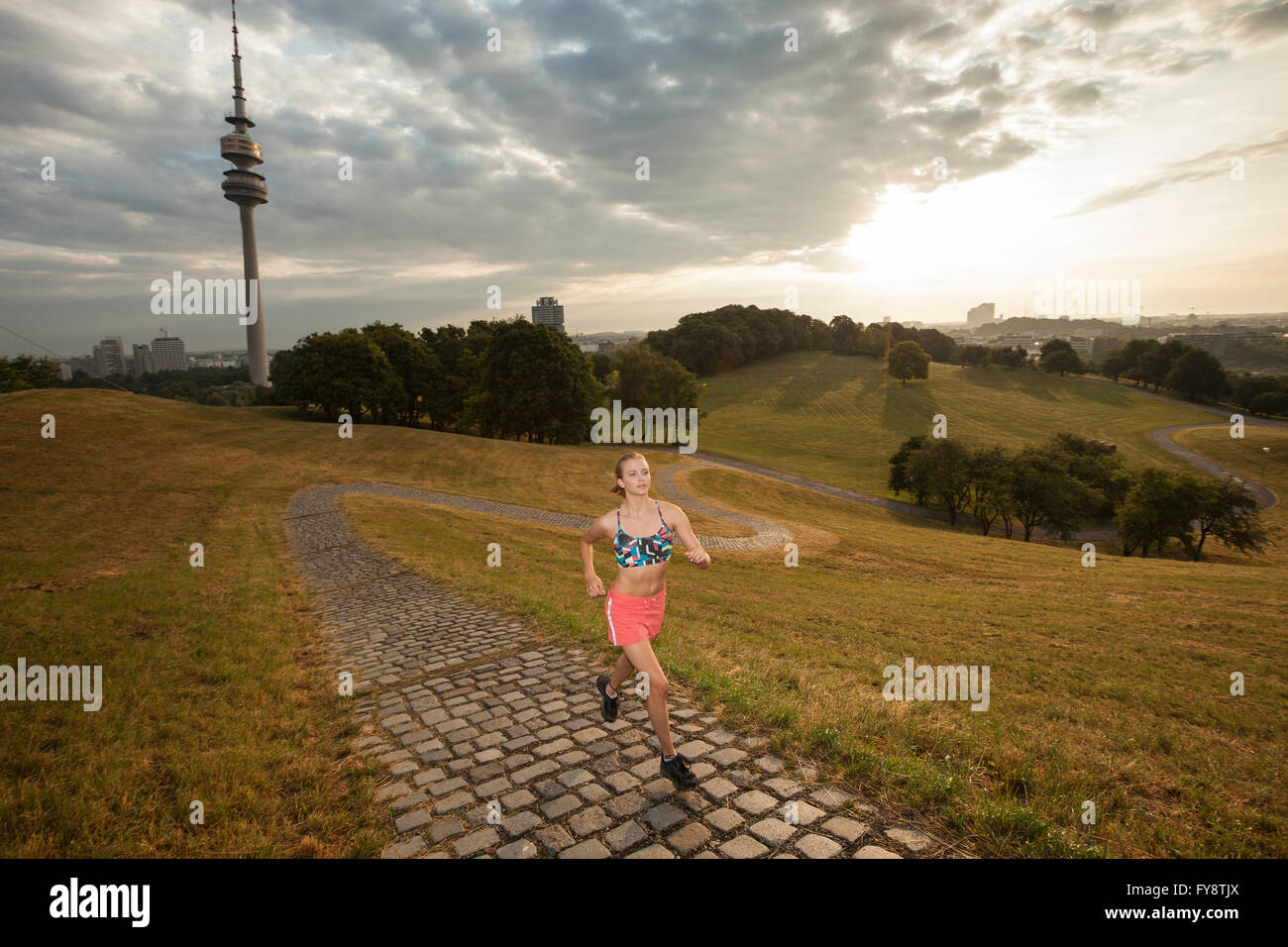 Germany, Munich, young woman jogging in the morning Stock Photo - Alamy
